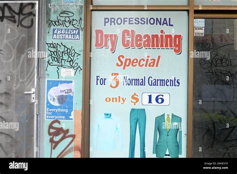 Detail Image Of An Old School Dry Cleaners Front Window With Faded