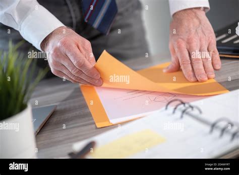 Businessman Opening Folder With Paper Documents Stock Photo Alamy