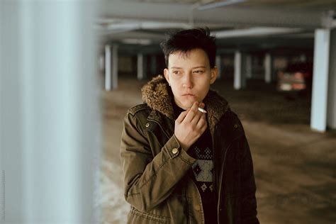 Real Lesbian Girl Smoking On The Parking Area By Stocksy Contributor