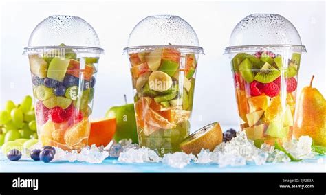 Abundance Of Tasty Chopped Fruits In Takeaway Plastic Cups Placed On