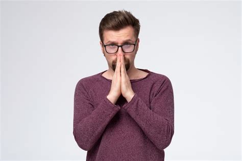 Premium Photo Concentrated Young Prayer In Eyeglasses Hoping For All