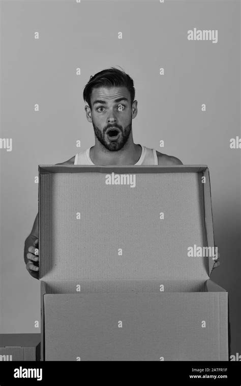 Man Holding Empty Cardboard Box Guy With Carton On Yellow Background Delivery And Moving In
