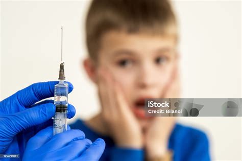 두려워하는 아이 소년에게 주사기로 예방 접종 주사를 준비하는 의사 학교 개념에서 아이들의 예방 접종 섬뜩한에 대한 스톡 사진 및 기타 이미지 Istock