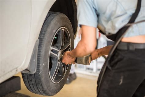 Premium Photo Midsection Of Man Working On Car In Garage