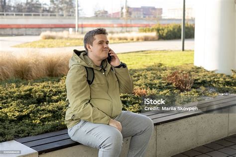 배낭을 메고 전화 통화를 하는 30대 남자는 야외에서 행복해 보입니다 도시 라이프 스타일 개념 봄 시간 현대 도시 거리를 걷는 잘 생긴 남자 고품질 사진 30 39세에 대한