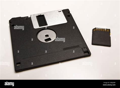Old Computer Technology Floppy Disk In Comparison With Sd Card Stock