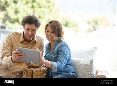 Logging Into Their Joint Email Account Shot Of A Husband And Wife Using A Digital Tablet