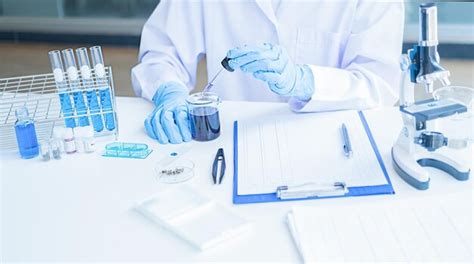 Premium Photo Midsection Of Scientist Doing Experiment On Table