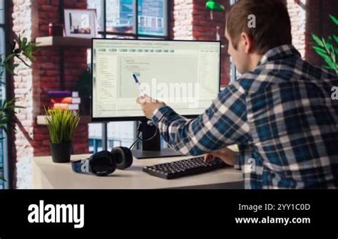 Programmer At Desk Types Code Into Computer Developing Software