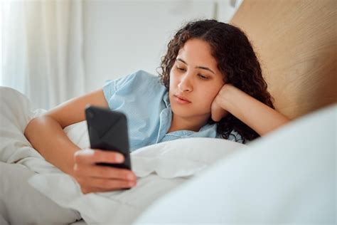Premium Photo Young Woman Checking Phone And Social Media In Bed Browsing Internet After