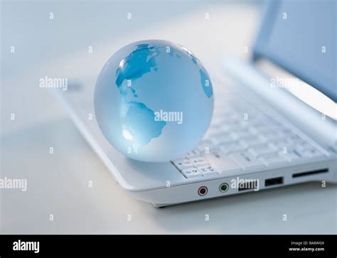 Globe On Laptop Keyboard Stock Photo Alamy