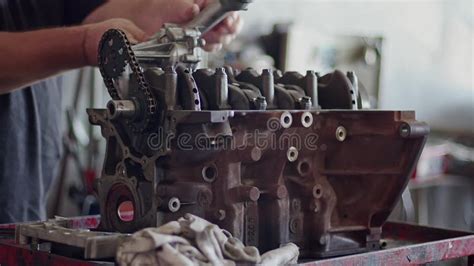 Parts Of Car Engine Being Repaired At Workbench In Repair Shop Stock