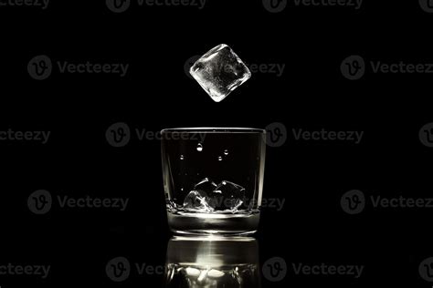 Ice Cube Falling Into Glass Of Water On Black Background 72518759 Stock