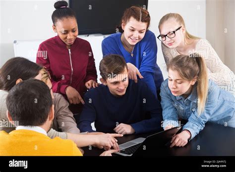 Friendly Classmates Having Difficult Project To Complete During Class