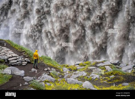 Tourist Standing At A Canyon Canyon With Falling Water Masses