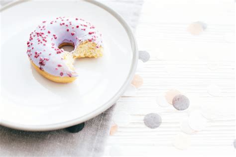 색종이와 흰색 테이블에 세련 된 접시에 뿌리와 도넛의 맛 있는 물린 파티 개념입니다 다이어트 없음 웨딩 리셉션에서 캔디 바