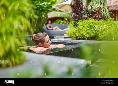 Beautiful Peaceful Woman Relaxing Outdoors In Sunny And Lush Stone