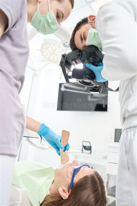 Stomatologist Taking Photos Of Client Teeth Before Primary Examination