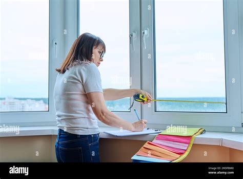 Woman Measuring Window With Tape Measure Tailoring Service Stock Photo Alamy