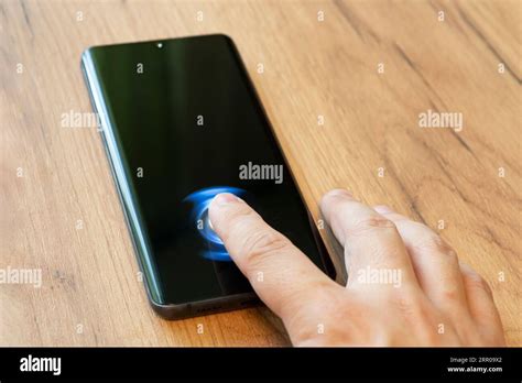 Close Up Of Man Using Generated Mobile Smart Phone With Fingerprint On The Screen Biometric