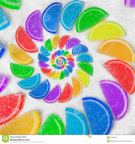 Abstract Spiral Fruit Jelly Rainbow Wedges Slices On White Sugar Sand