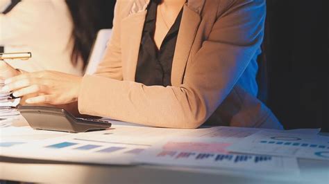 A Woman Is Using A Calculator To Calculate The Cost Of A Project 56321515 Stock Video At Vecteezy