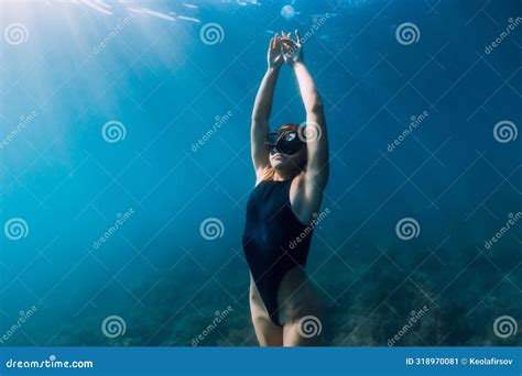 Slim Woman Underwater In Blue Ocean Freediving And Beautiful Lady