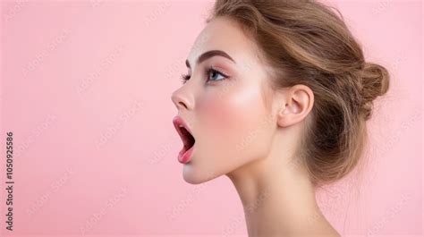 Profile Of A Beautiful Woman With Open Mouth Against Pink Background