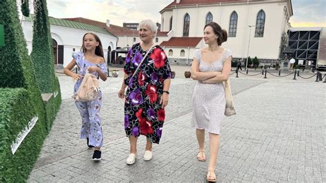 Grandmother And Two Granddaughters Are Walking Around The City On The