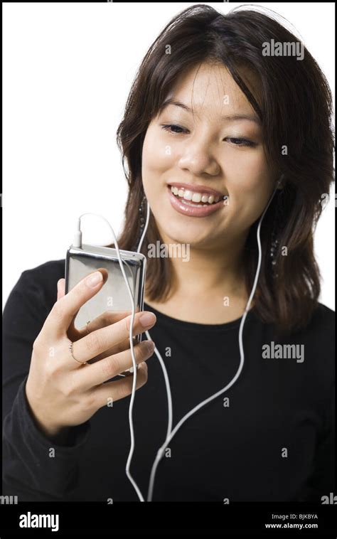 Woman With Mp Player Smiling Stock Photo Alamy