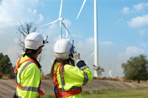 Man And Female Engineer Stationed At The Natural Energy Wind Turbine Site With Daily Audit