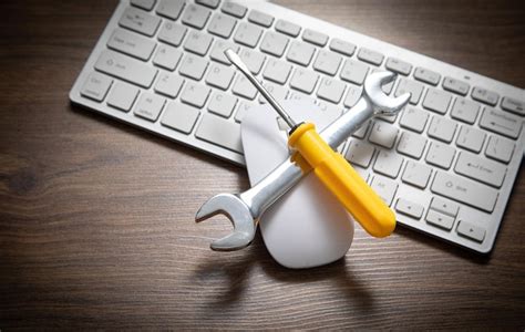 Premium Photo Wrench And Screwdriver With A Computer Keyboard It Premium Photo Wrench And Screwdriver With A Computer Keyboard It