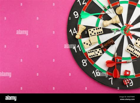Dart Board With Components Of Tabletop Games On Pink Background Top View Space For Text Stock