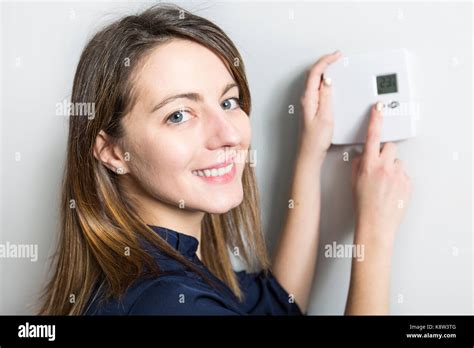 Woman Set The Thermostat At Home Stock Photo Alamy