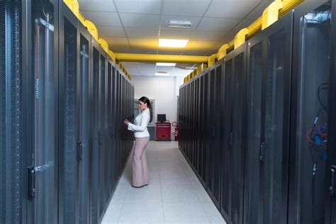 Premium Photo Female It Engineer Working On A Tablet Computer In Server Room At Modern Data Center