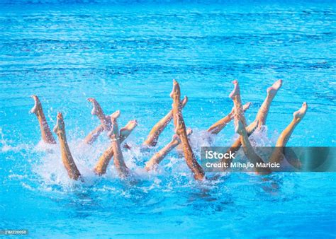 Artistic Swimming Team Performing Synchronized Legs Movement In