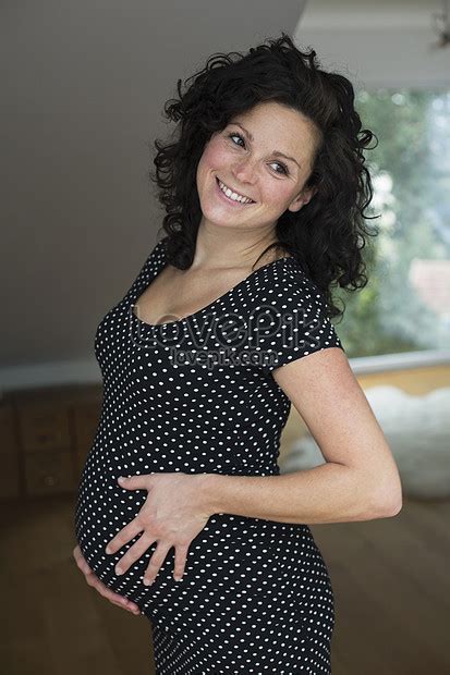 Photo Of Smiling Pregnant Middle Aged Woman Touching Belly Picture And