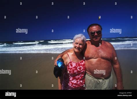Grey Haired Couple In Love Hugging On Beach Maroochydore Queensland