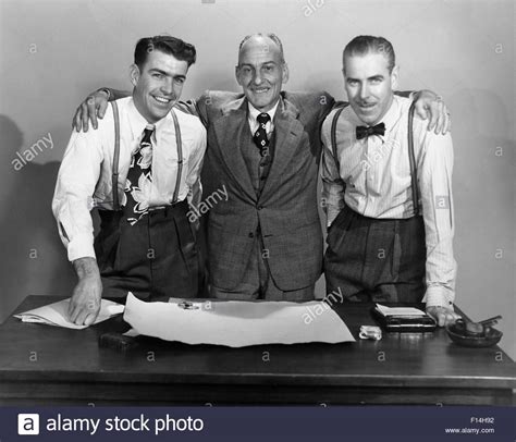 1950s 3 Generations Of Businessmen At Desk In Arms Smiling At Camera