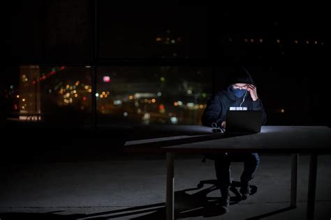 Hacker Using Laptop Computer While Working In Dark Office Stock Photo At Vecteezy