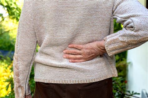 Close Up Of Old Woman Rubbing Her Lower Back Stock Image Image Of Discomfort Painful