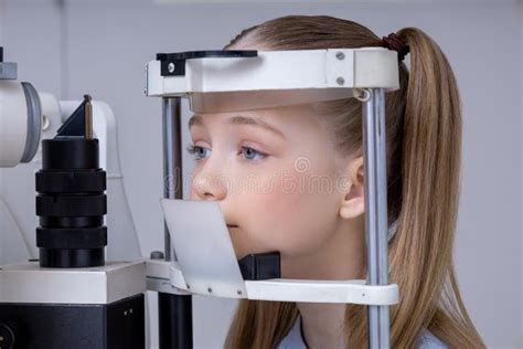 Cute School Age Girl Having An Optometric Test At The Doctors Office