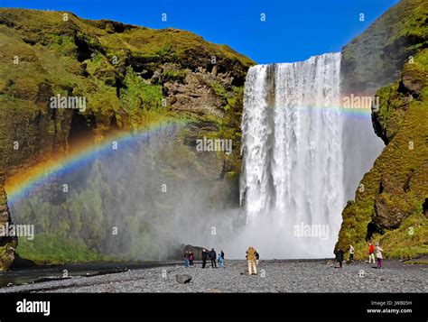 Skogafoss Waterfall And Rainbow With Incidental Tourists Skogafoss Is