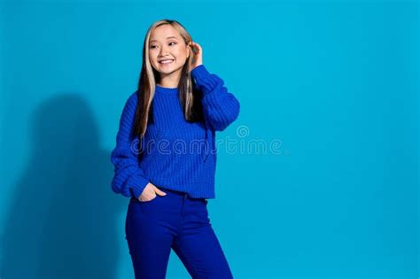 Portrait Of Young Sweet Model Chinese Woman In Blue Knitted Sweater