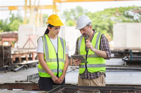 Senior Engineer And Female Foreman Team Checking Project At Precast Concrete Factory Site