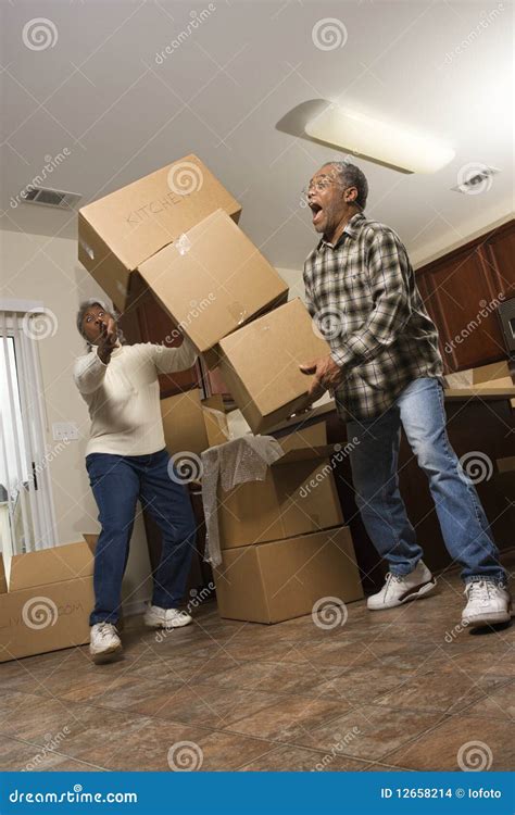 man dropping stack of boxes stock images image 12658214