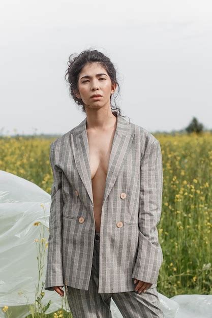 Premium Photo An Asian Model Poses In A Field Of Yellow Flowers For A