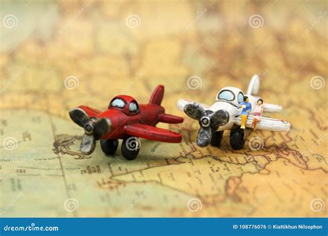 Miniature People Women Sitting On Mini Airplane With World Map Stock
