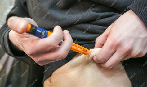 Premium Photo A Diabetic Man Injecting Himself With Insulin Before Eating Insulin Injection