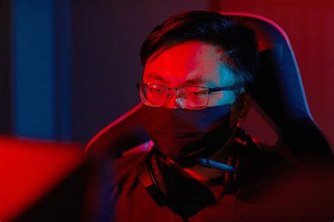 Premium Photo Asian Programmer In Eyeglasses And In Protective Mask